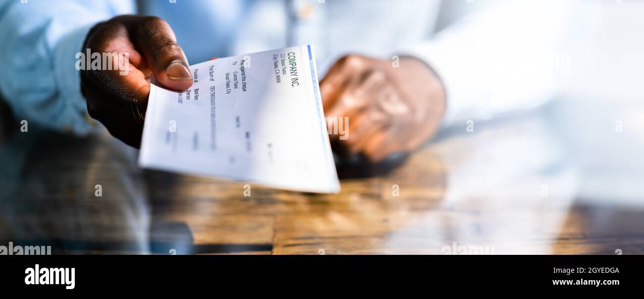 African Business Man Giving Paycheck Or Payroll Cheque Stock Photo - Alamy