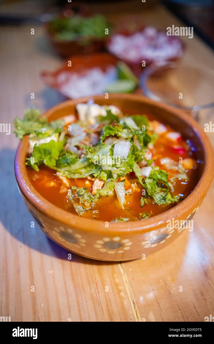 Clay bowl of condiments and delicious traditional Mexican pozole Stock ...