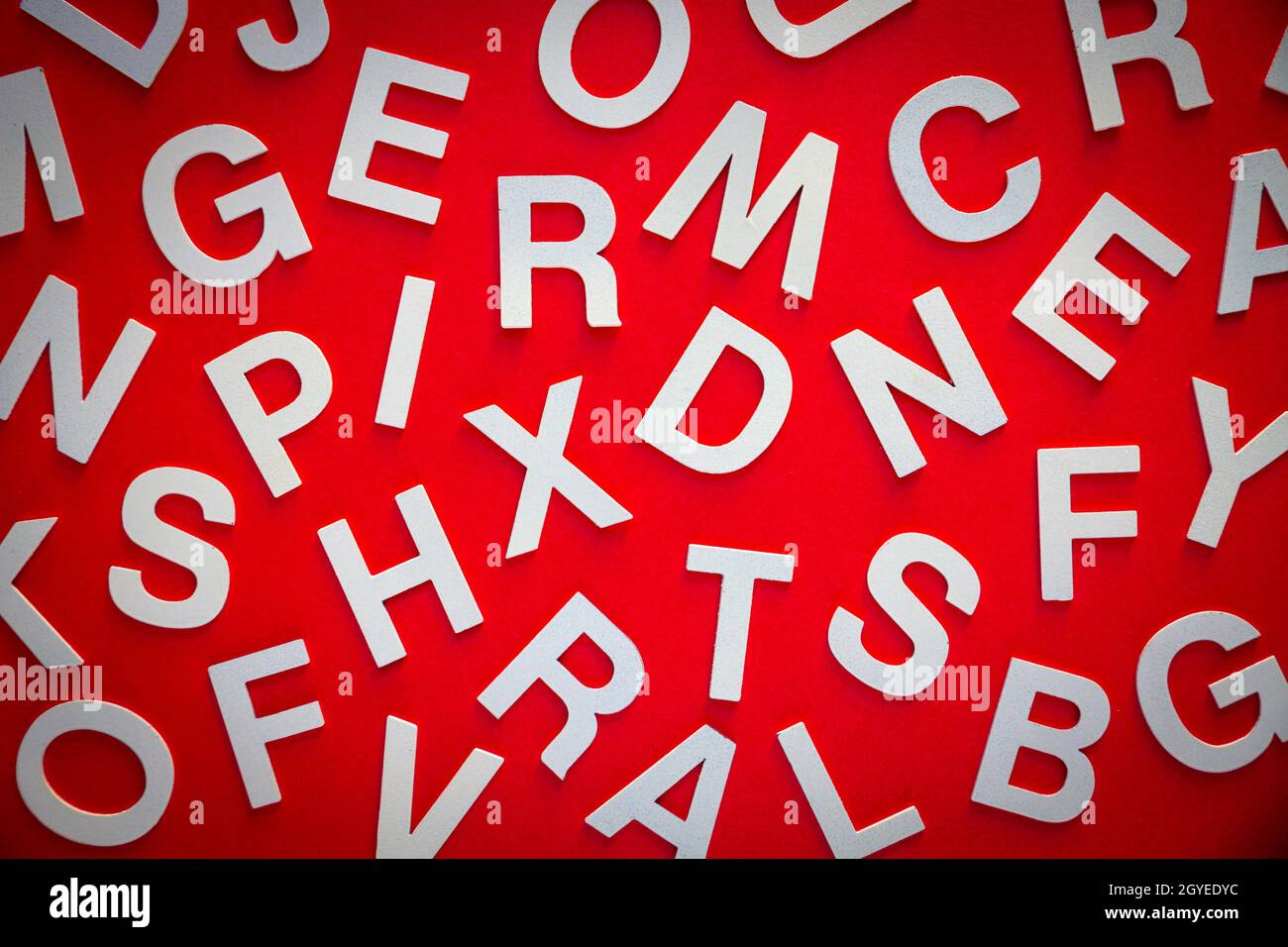 Mixed solid letters pile top view photo. Education concept on red ...