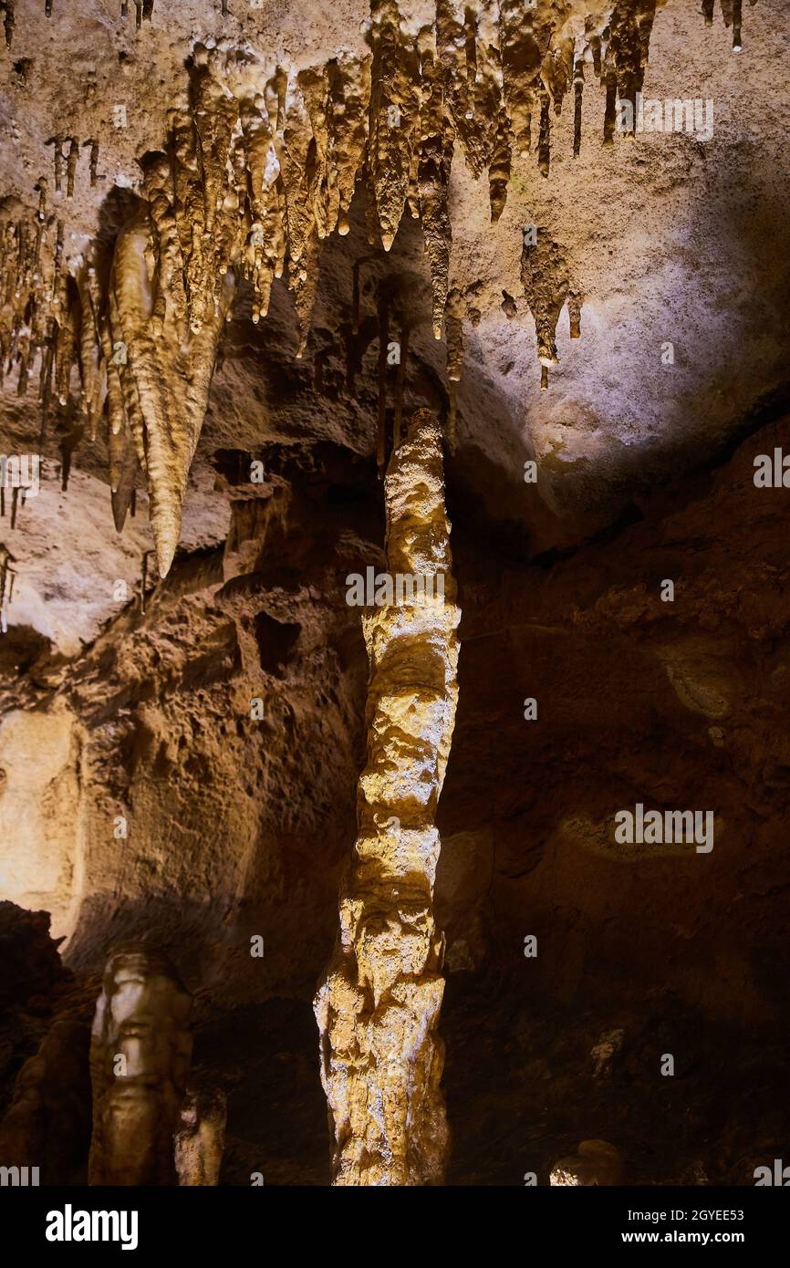 Large stalagmite and stalactites in golden cave Stock Photo - Alamy