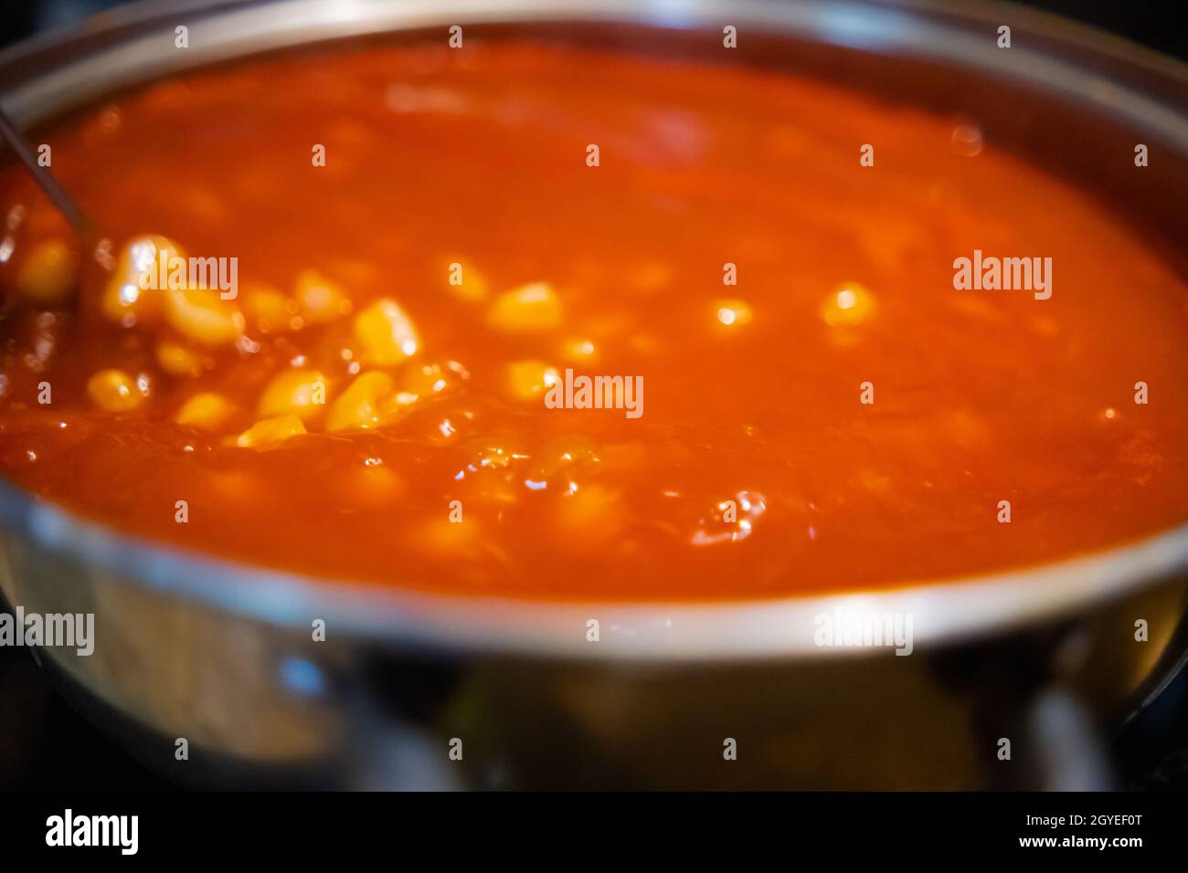Delicious traditional Mexican pozole with corn kernels in cooking pot ...