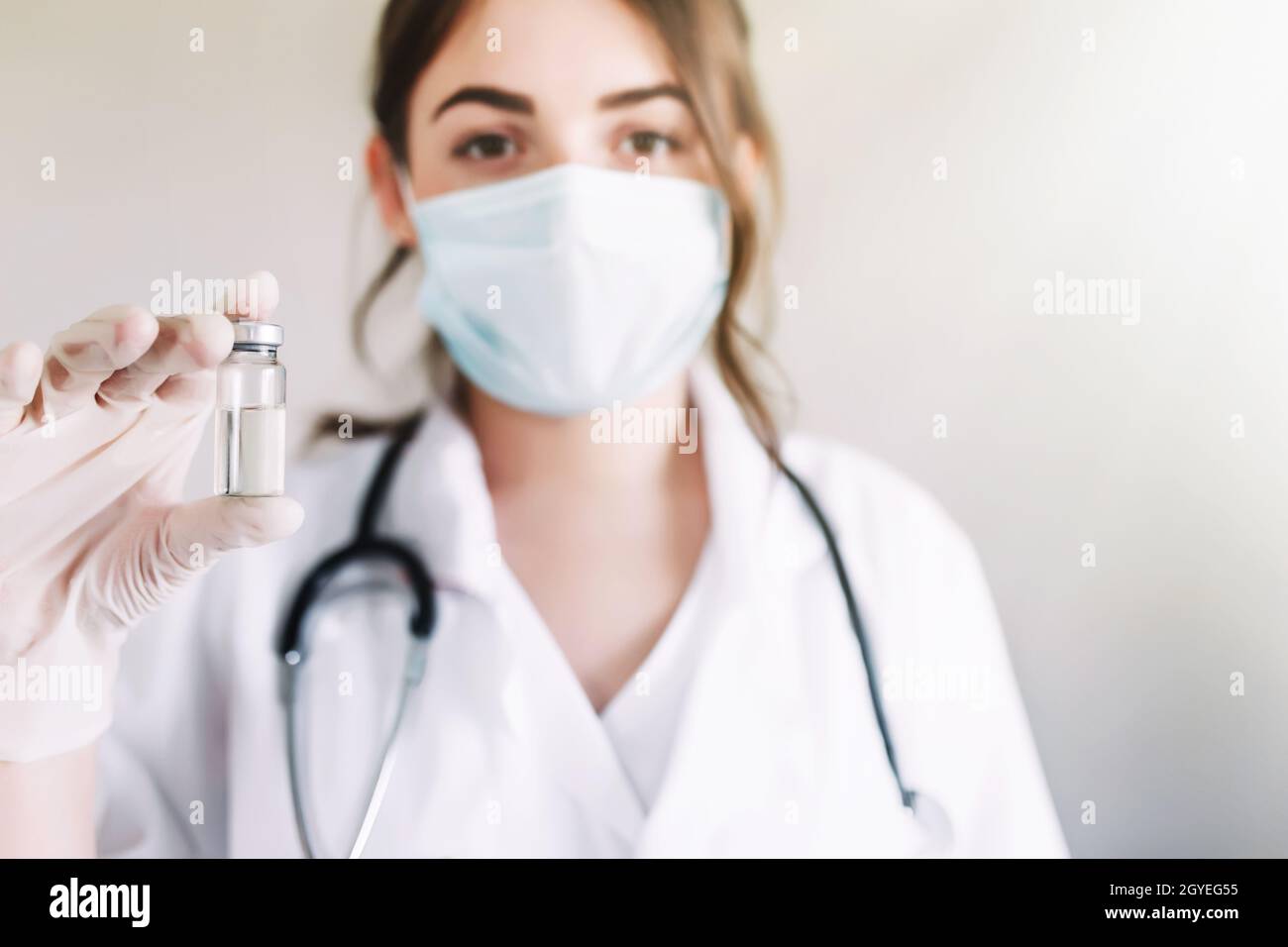 Woman nurse holding vial in hi-res stock photography and images - Alamy