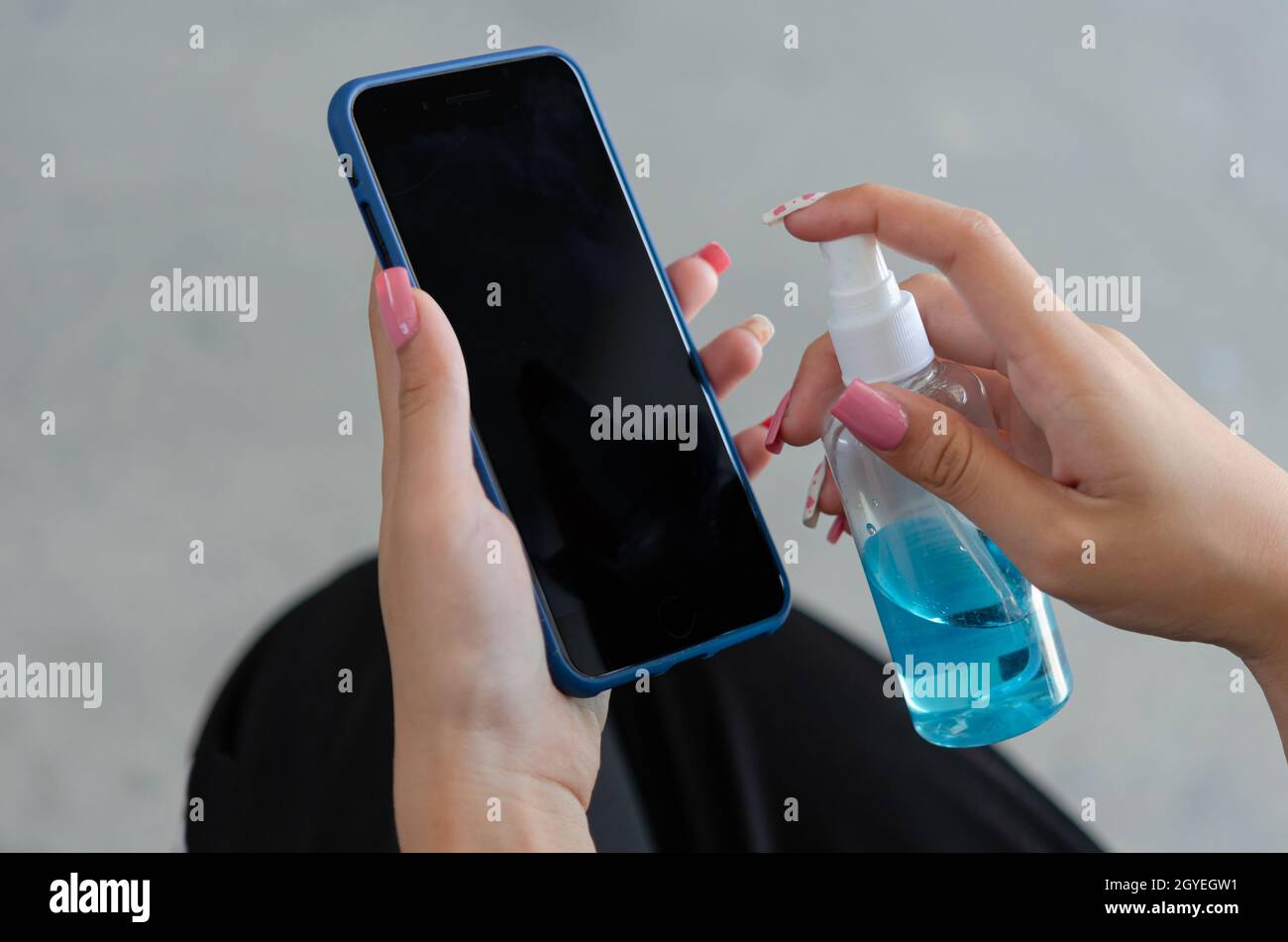 Wipe and disinfect your mobile phone with alcohol. concept of health ...