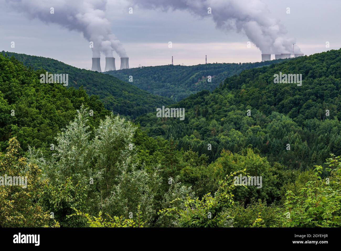 Valleys covered with forest and on the horizon are the cooling towers ...