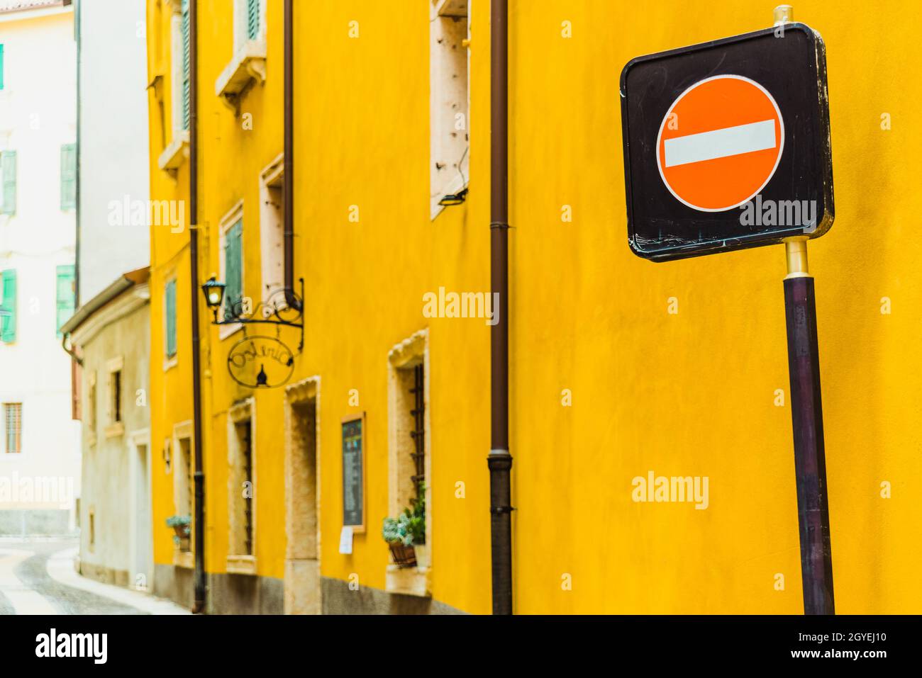 Forbidden direction sign in a narrow lane in a European town Stock ...
