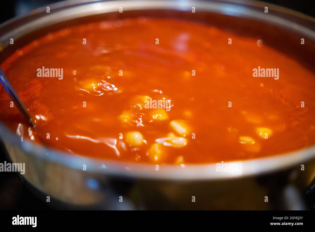 Delicious traditional Mexican pozole with corn kernels in cooking pot ...