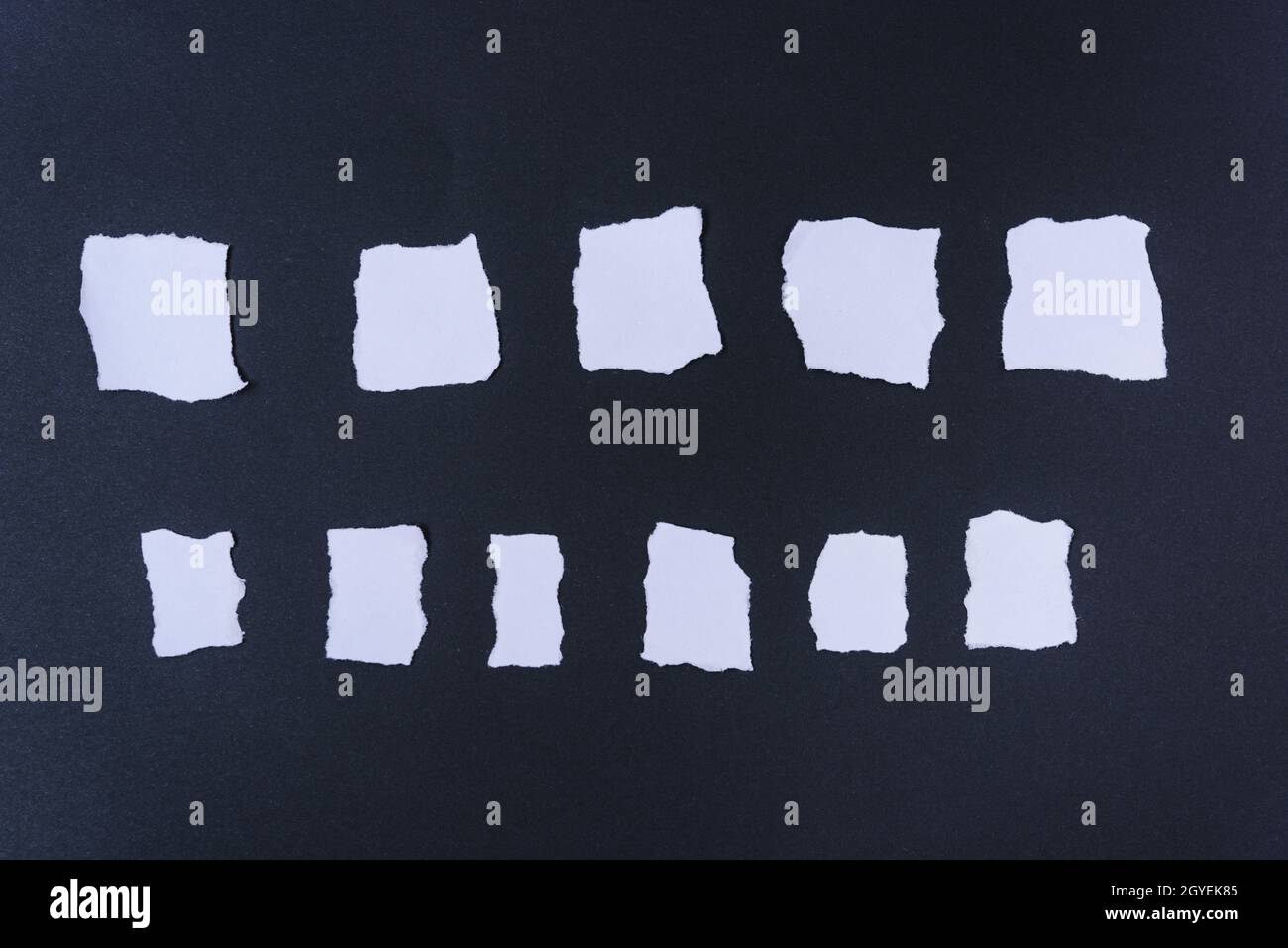 White paper torn into words on a black background Stock Photo - Alamy