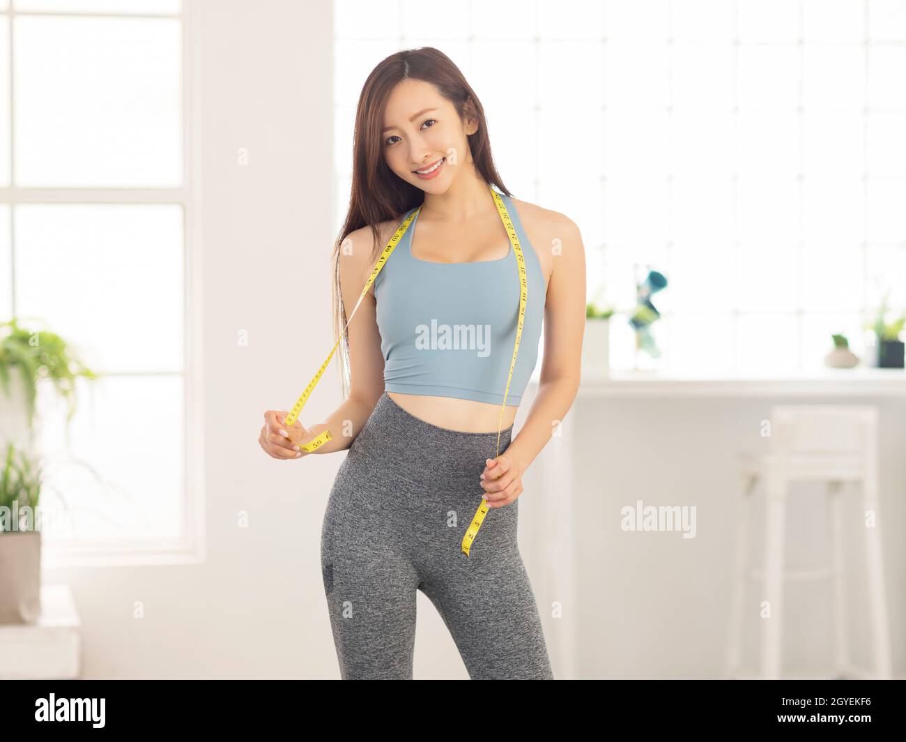 Slim Young woman and measure tape around her body Stock Photo - Alamy