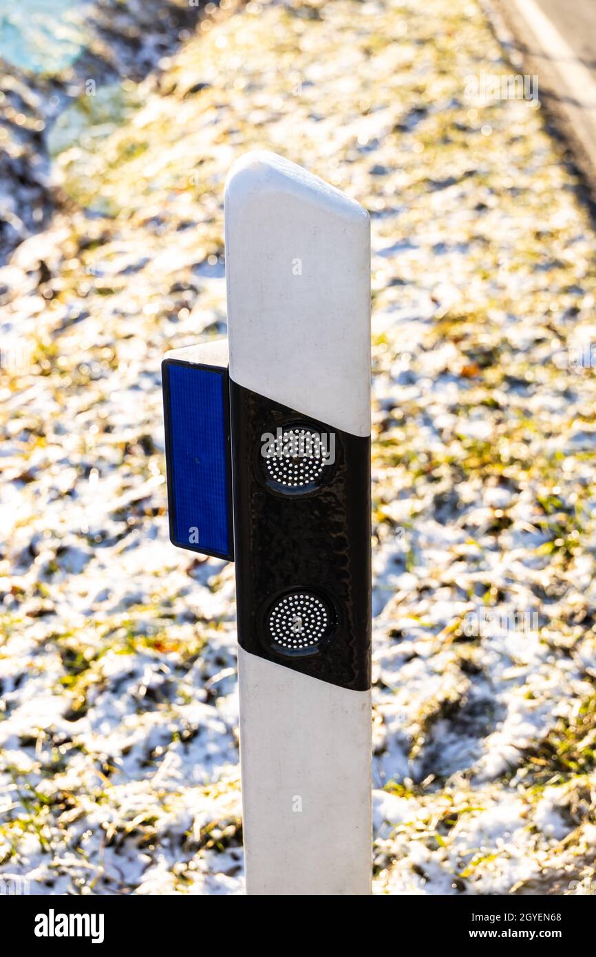 Road Marker in detail with snowy background Stock Photo - Alamy