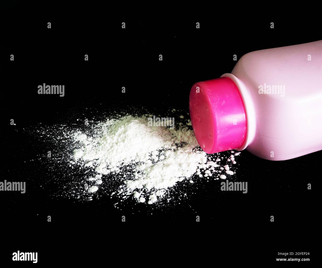 Baby talcum powder pink container on black background Stock Photo - Alamy