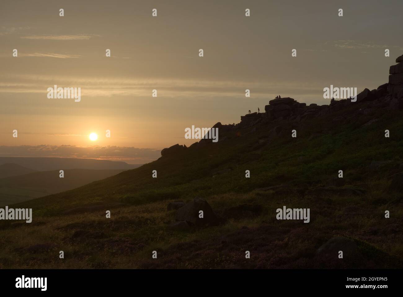 Climbers, couples and tourists line the rocky ridge of stanage edge at ...