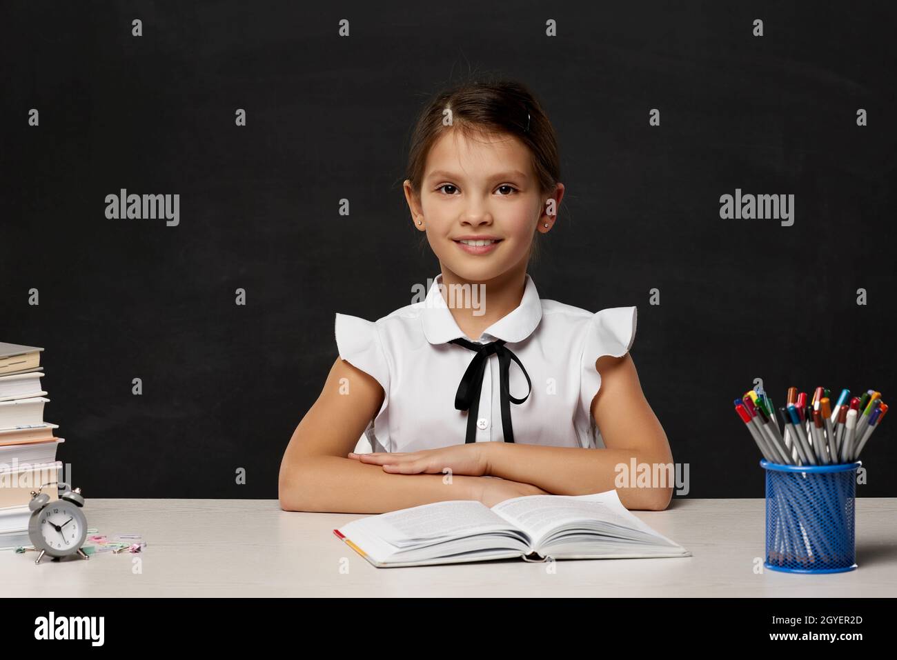 cute little child girl reading a book in the classroom on background of ...