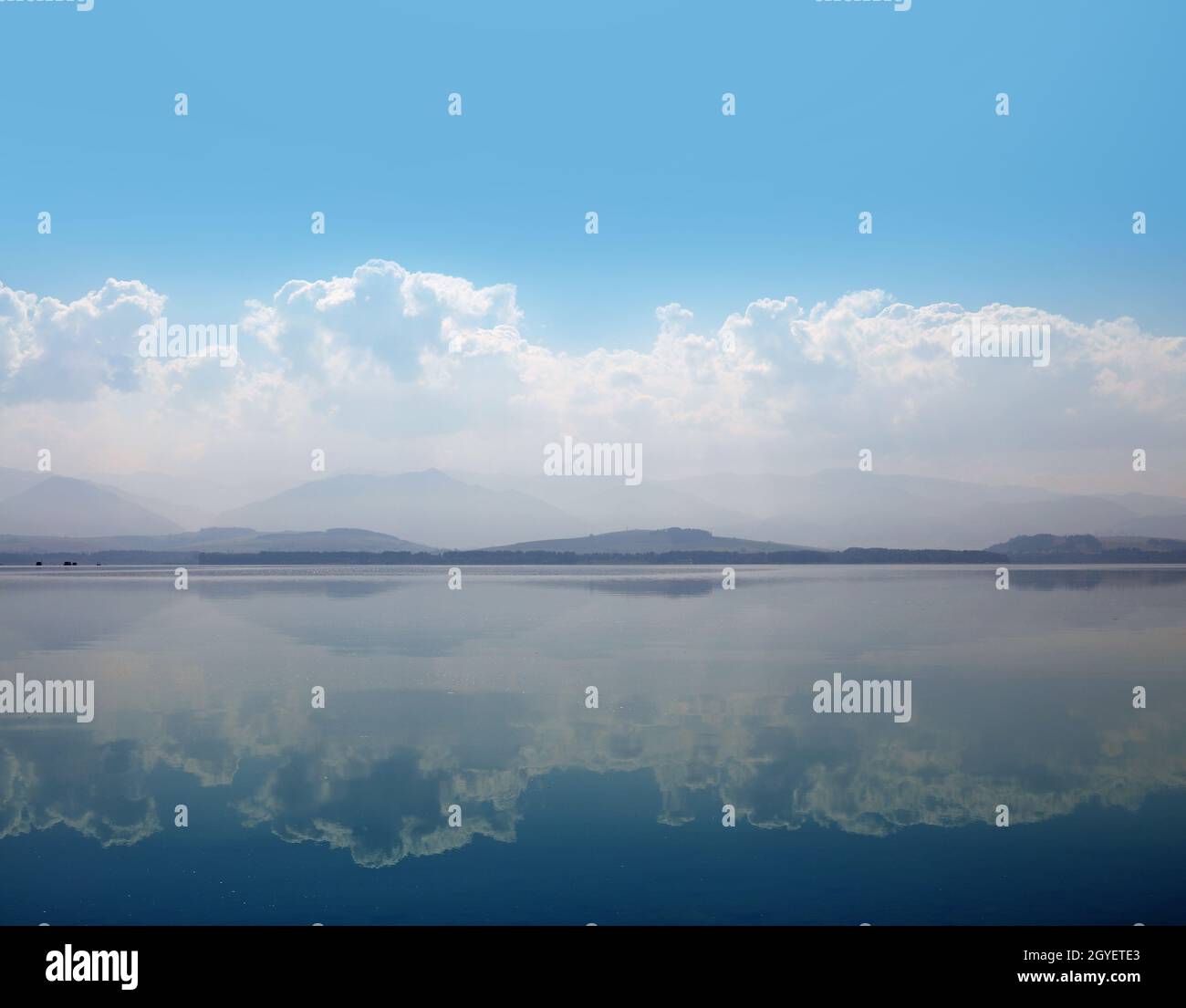 Waterscape of lake water with cloudy sky reflection Stock Photo - Alamy