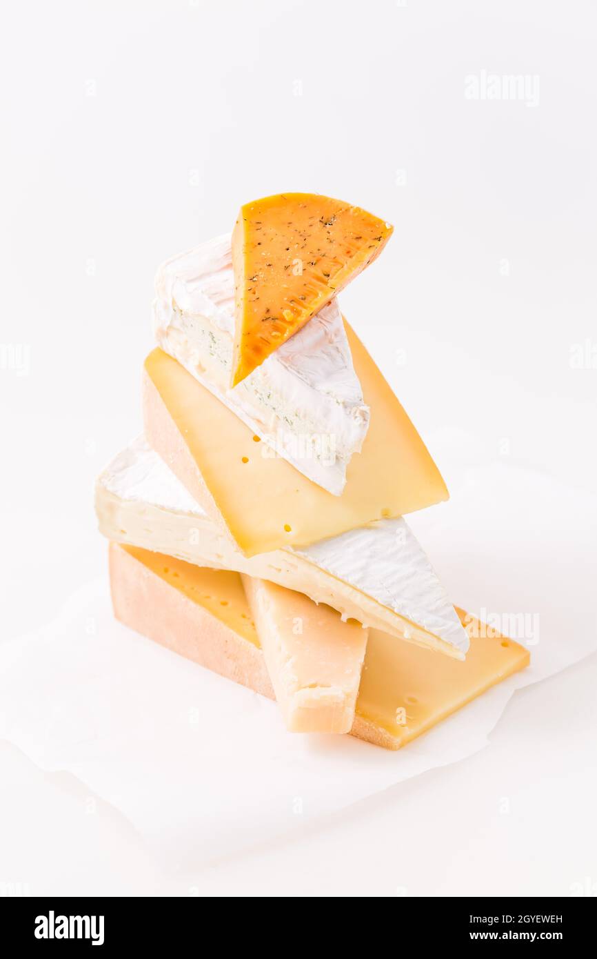 Assortment of different cheeses on white background. Hard cheese ...