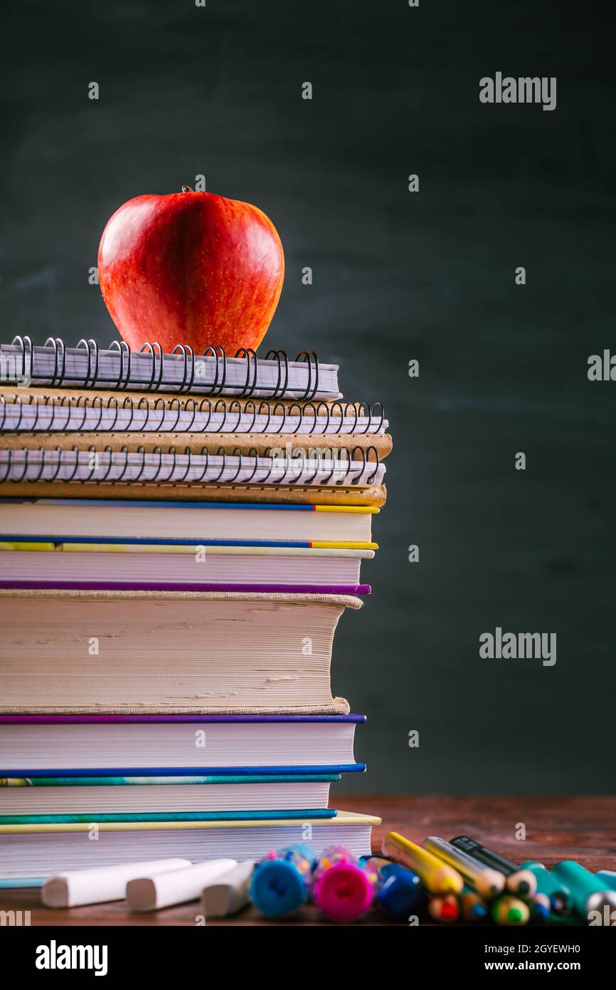 Pile of book and exercise books with school applies and apple snack ...