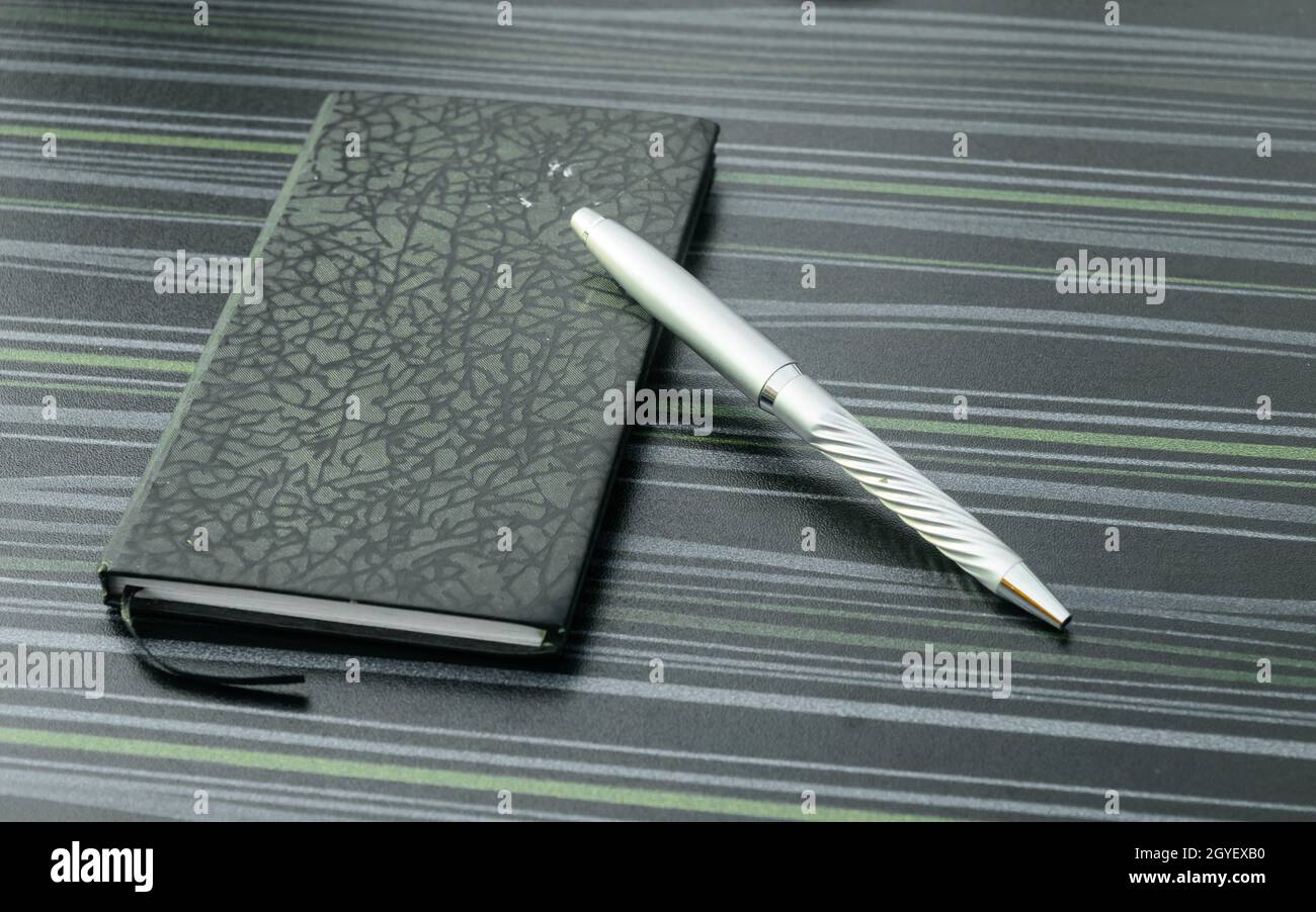 Pen and notebook on office table. Table top view. Corporate business ...