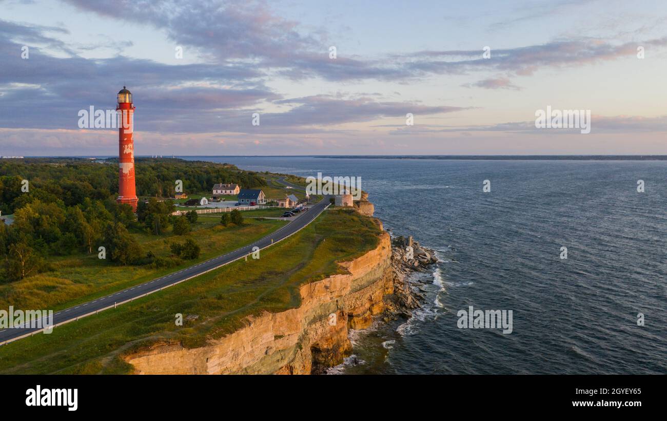 Coastal limestone cliff landscape with the lighthouse and wind turbines ...