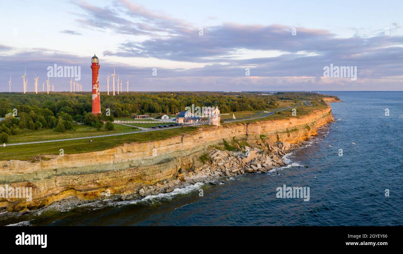 Coastal limestone cliff landscape with the lighthouse and wind turbines ...