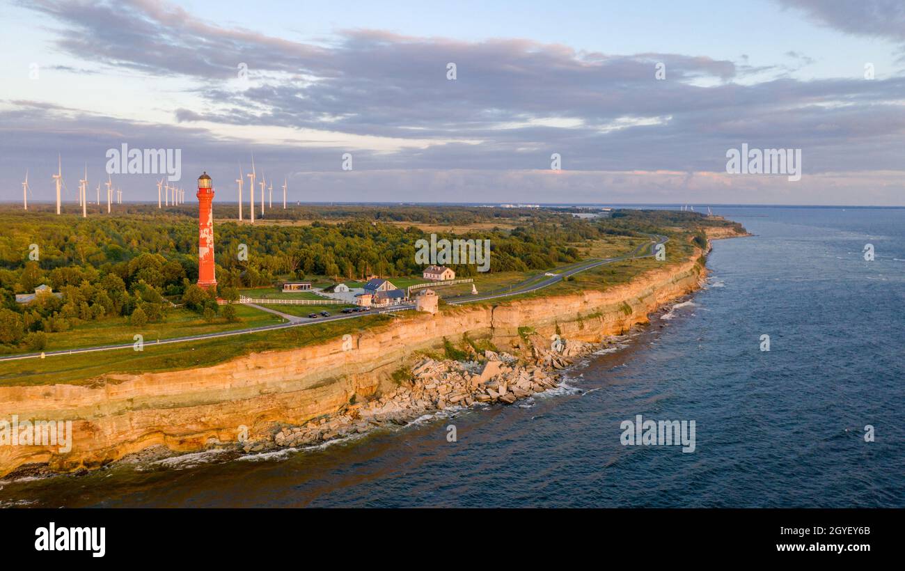 Coastal limestone cliff landscape with the lighthouse and wind turbines ...