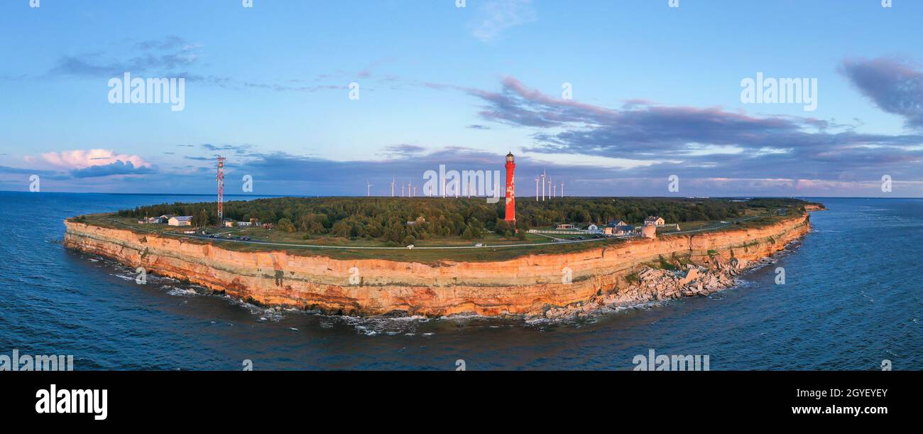 Coastal limestone cliff landscape with the lighthouse and wind turbines ...