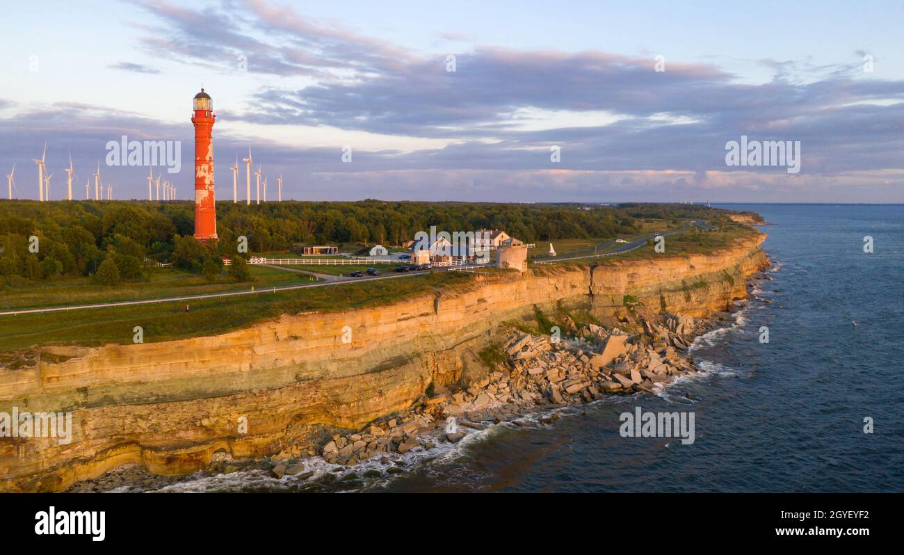 Coastal limestone cliff landscape with the lighthouse and wind turbines ...