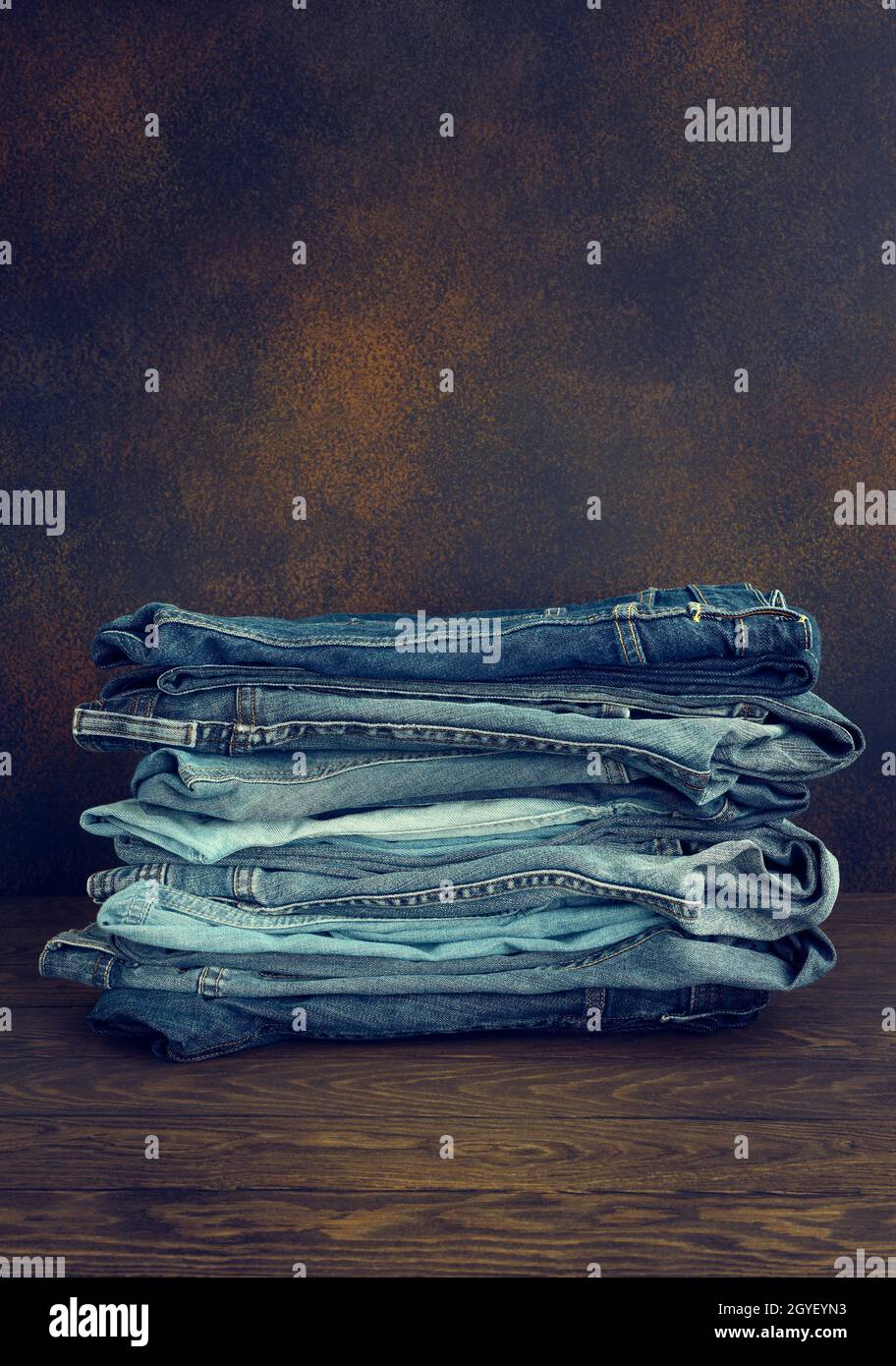 Denim pants stack on wood shelf Stock Photo - Alamy