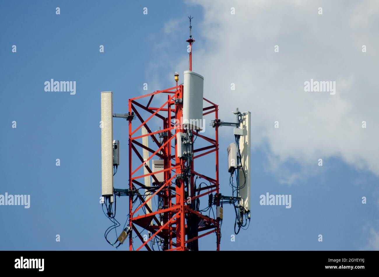 Telephone and Internet transmission towers on sky and cloud background ...