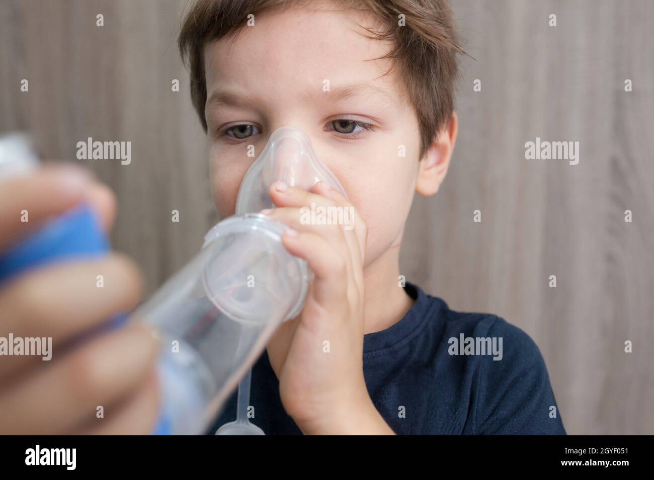 Child boy using medical spray for breath. Inhaler, spacer and mask ...
