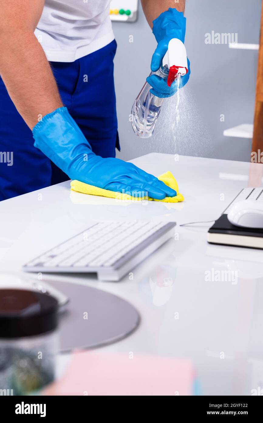 Office Cleaning Service. Janitor Spraying Desk. Workplace Hygiene Stock ...