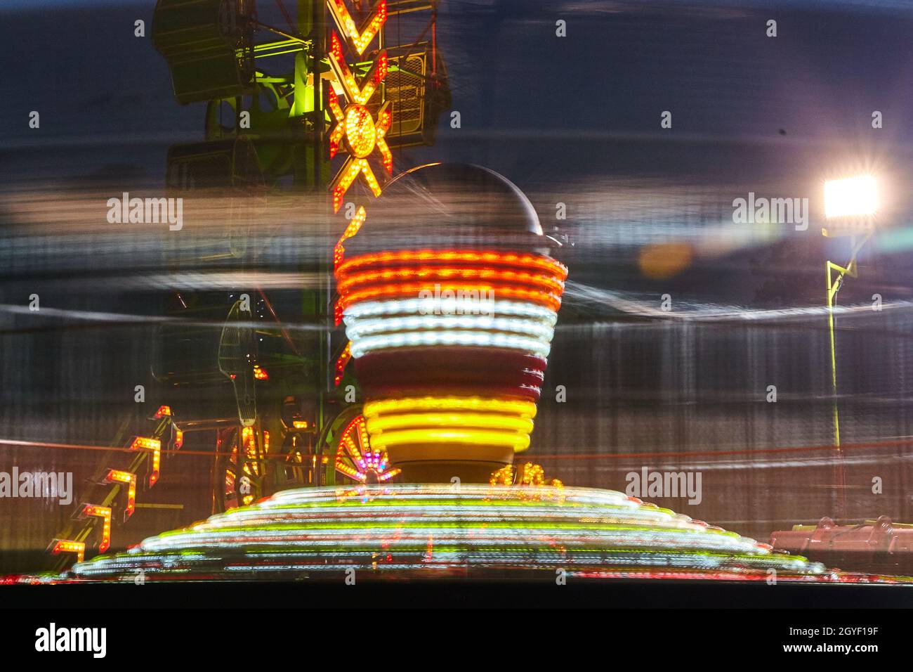 Yellow, red and white spinning together on a carnival or fair ride ...