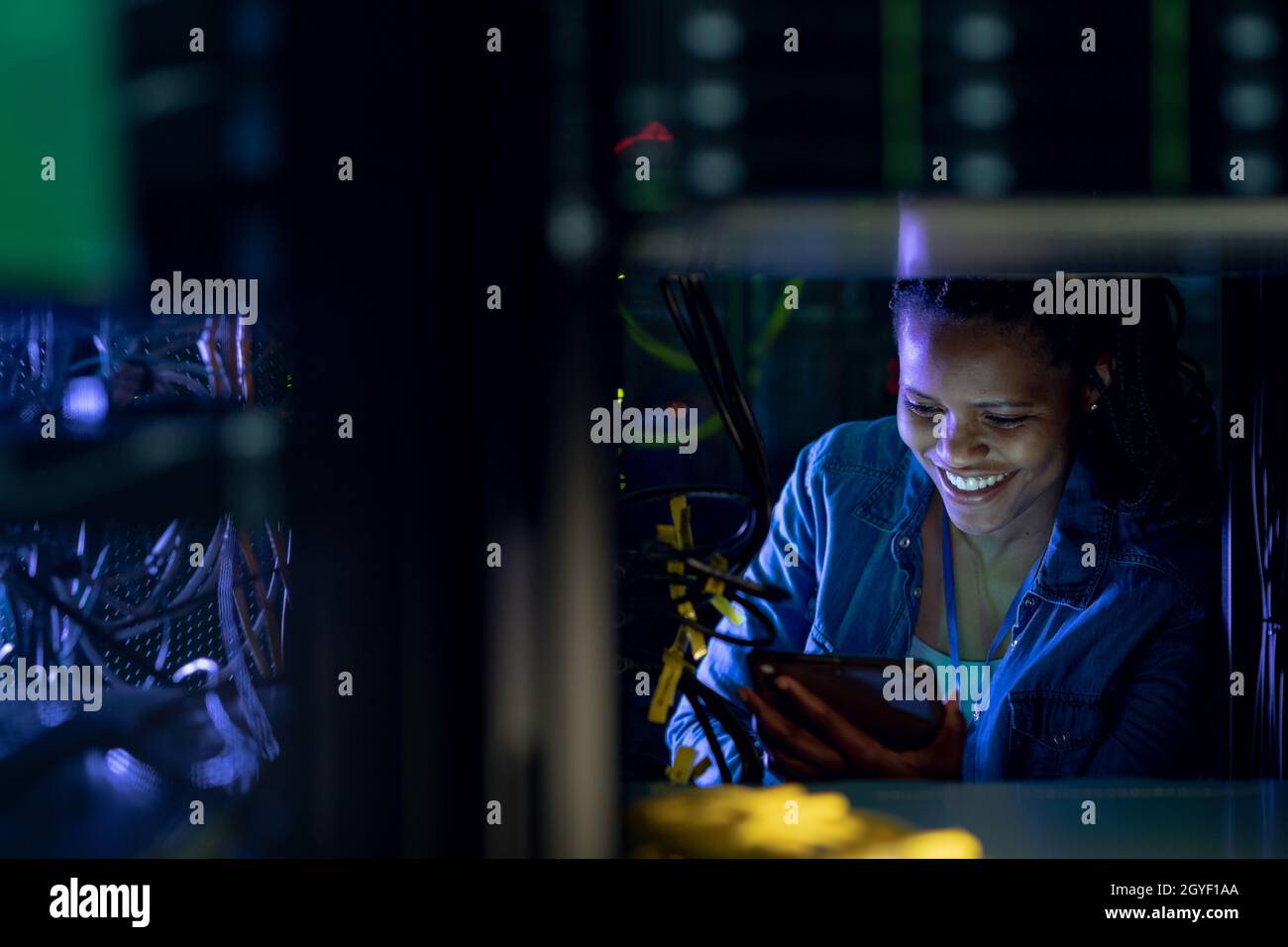 African american female computer technician using tablet and working in ...