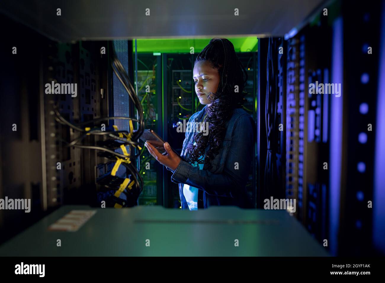African american female computer technician using tablet and working in ...