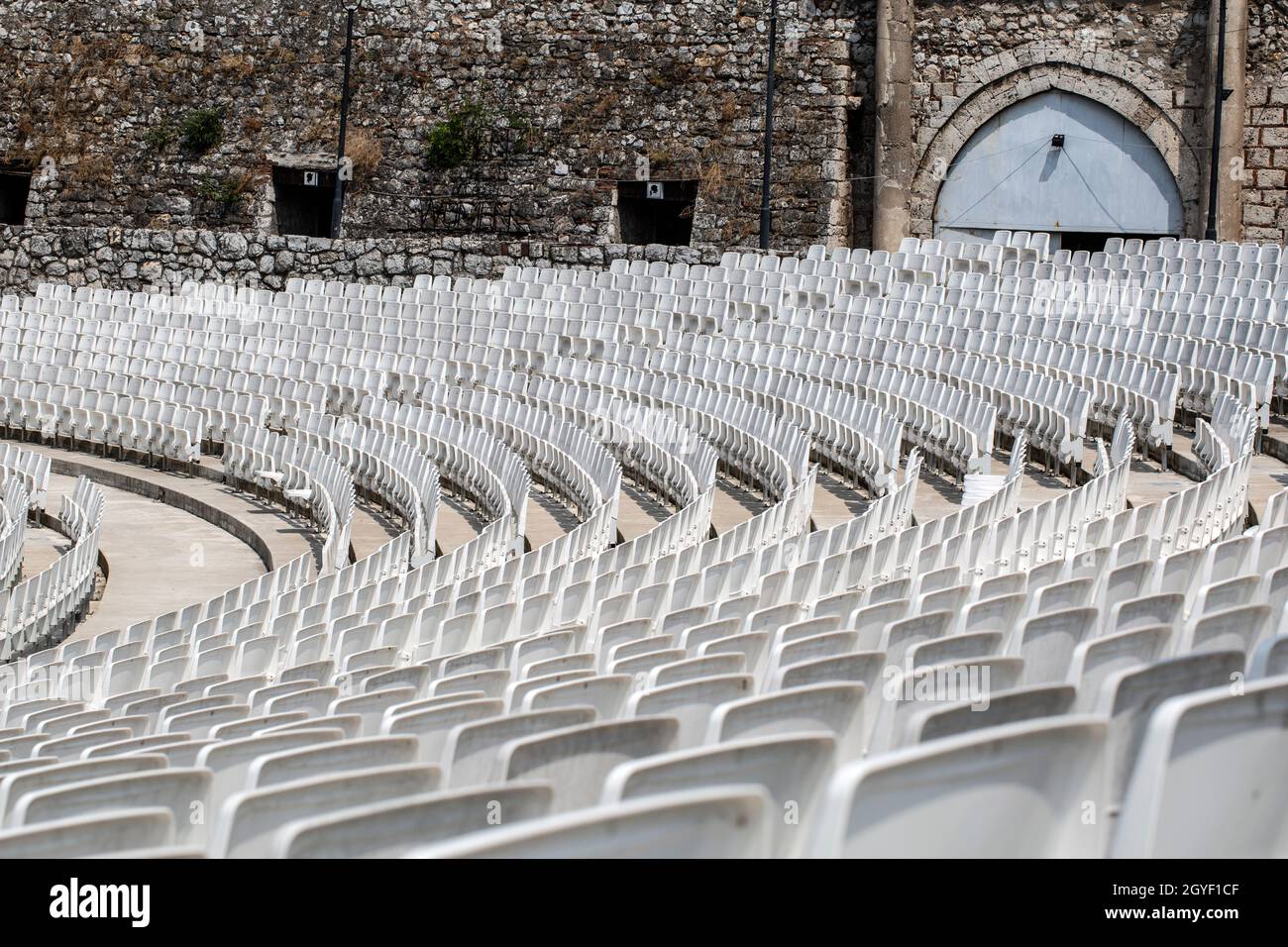 The empty auditorium with gray plastic chairs in an ancient ...