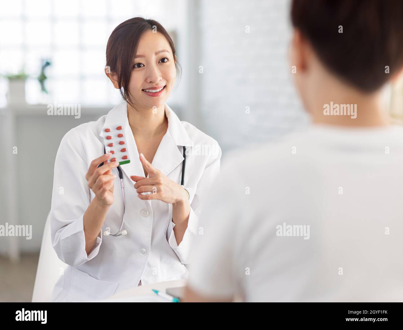 Doctor is pointing to drug tablet and introducing to patient Stock ...