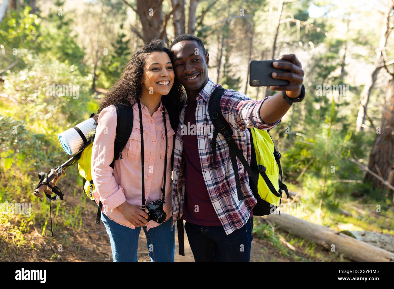 Happy diverse couple backpacks hi-res stock photography and images - Alamy
