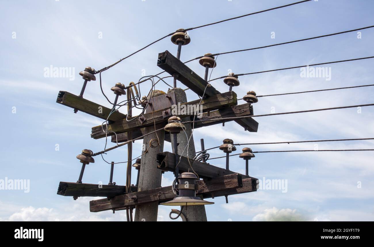 Wooden electric pole with high voltage wires close-up. Pillar against ...