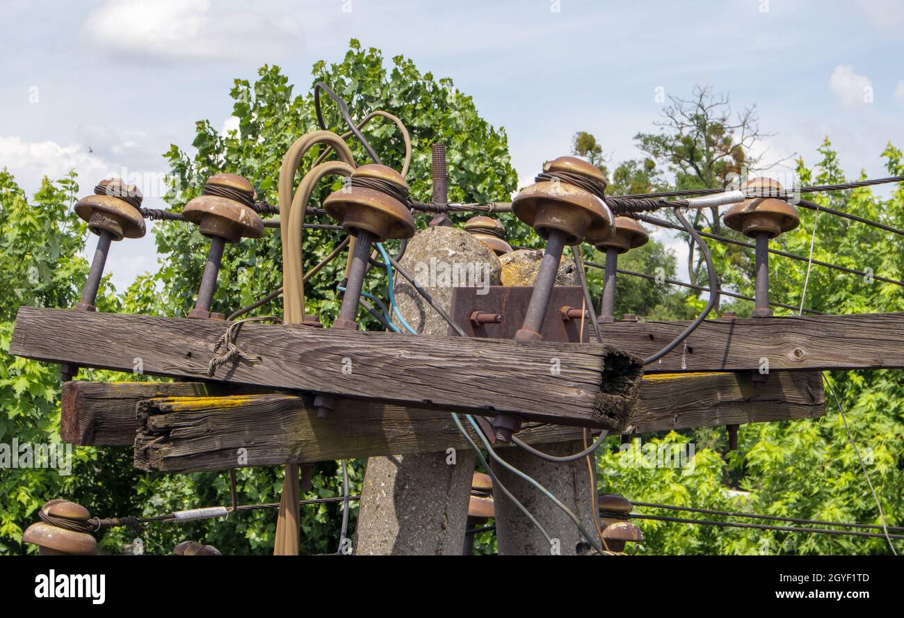 Wooden electric pole with high voltage wires close-up. Pillar against ...