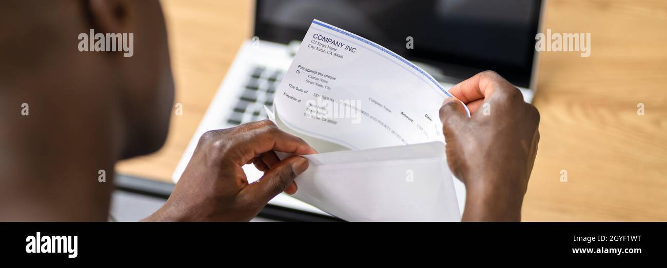 African Opening Payroll Cheque. Salary Payment Check Stock Photo - Alamy