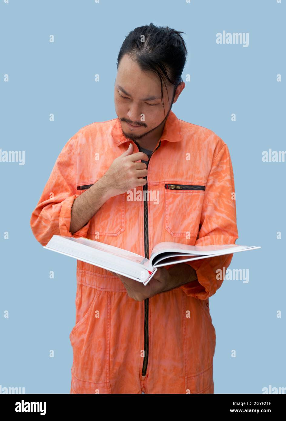 The chief mechanic in an orange uniform holding big book. Stand and ...