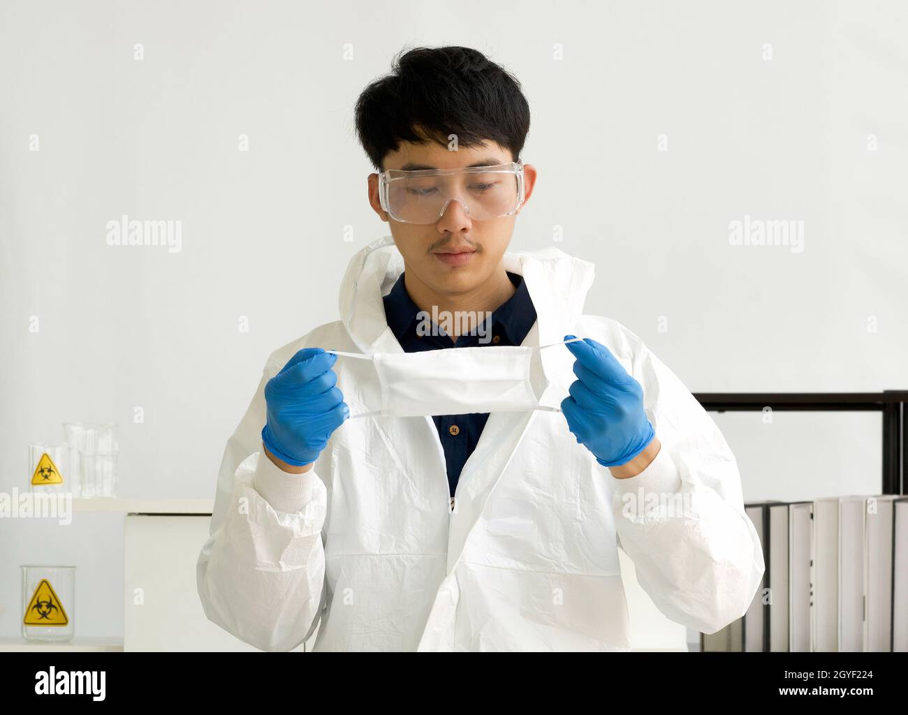 Asian scientist in virus protective clothing, inspect the quality of a ...