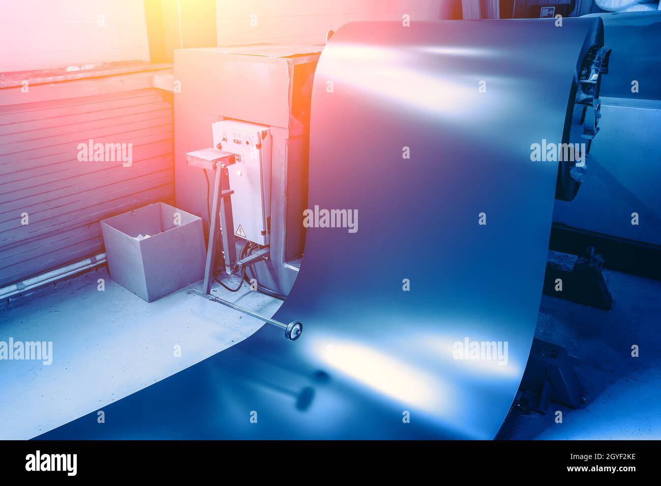 Metal sheet roll in industrial forming machine at factory workshop ...