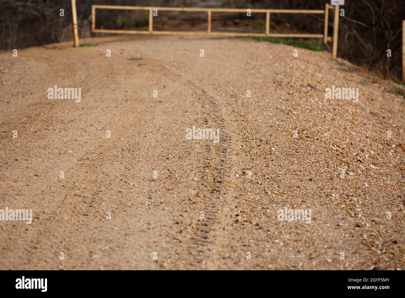 Tire track leading down a rocky, gravel road Stock Photo - Alamy
