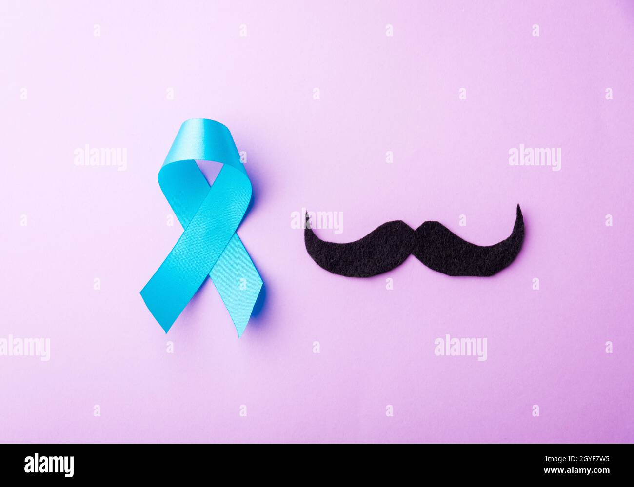 Black mustache paper and light blue ribbon, studio shot isolated on ...