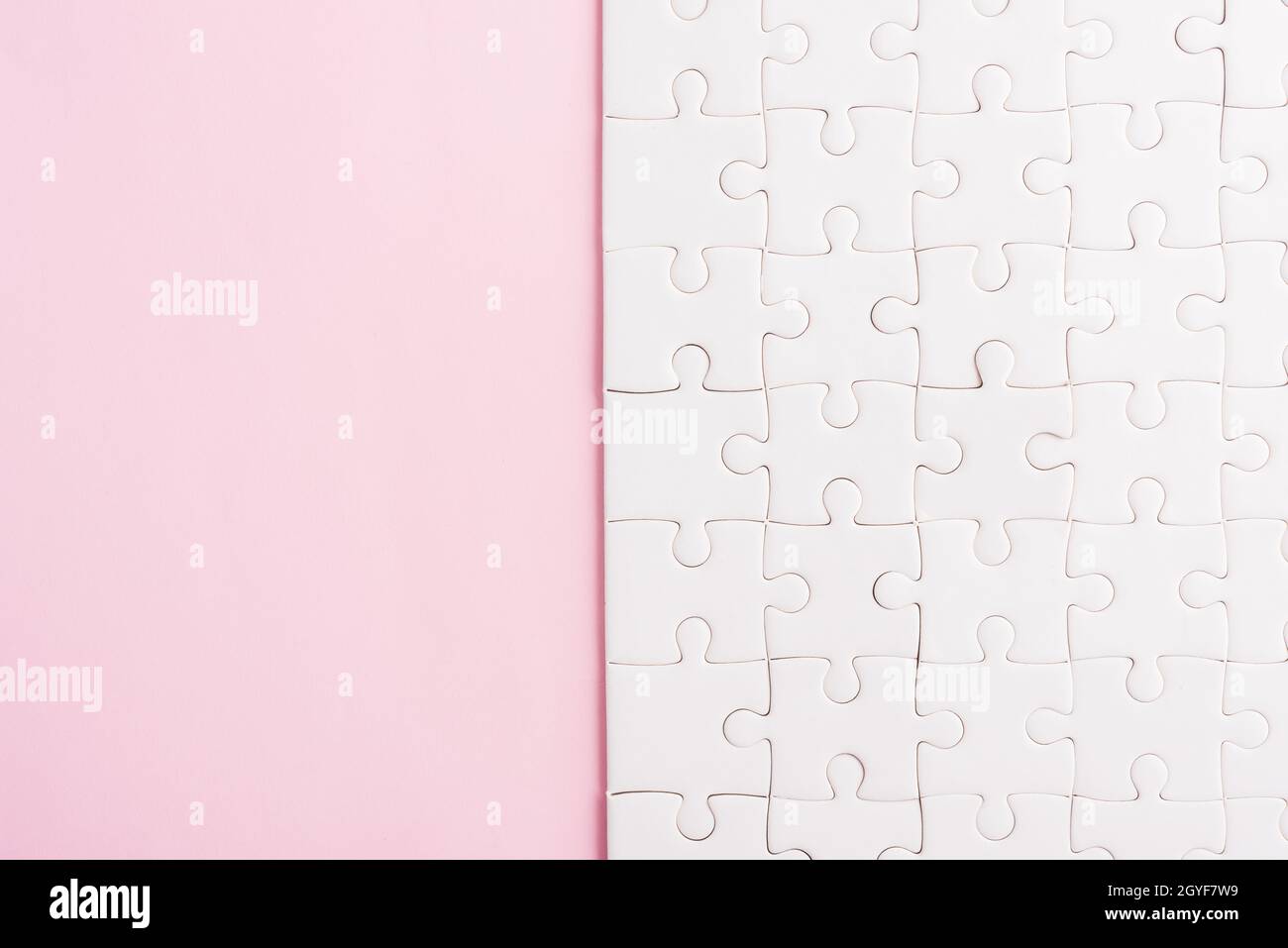 Top view flat lay of paper plain white jigsaw puzzle game texture on a ...