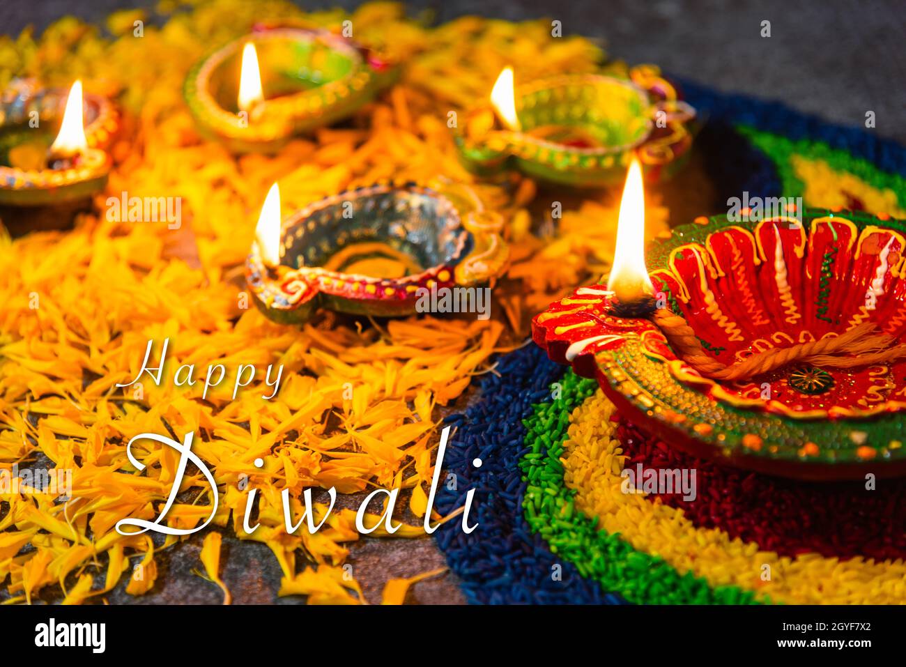 Close up clay lit light a fire already on Diya or oil lamp with flowers ...