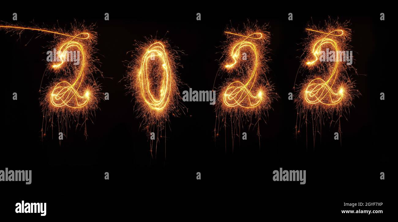 The year 2022 written with a sparkler on black background, New Years ...