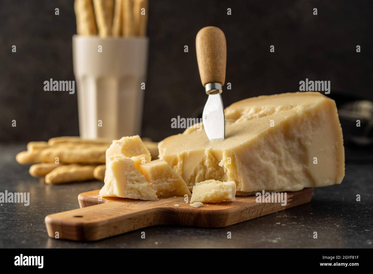 Pieces of italian parmesan cheese. Block of parmesan on kitchen table ...