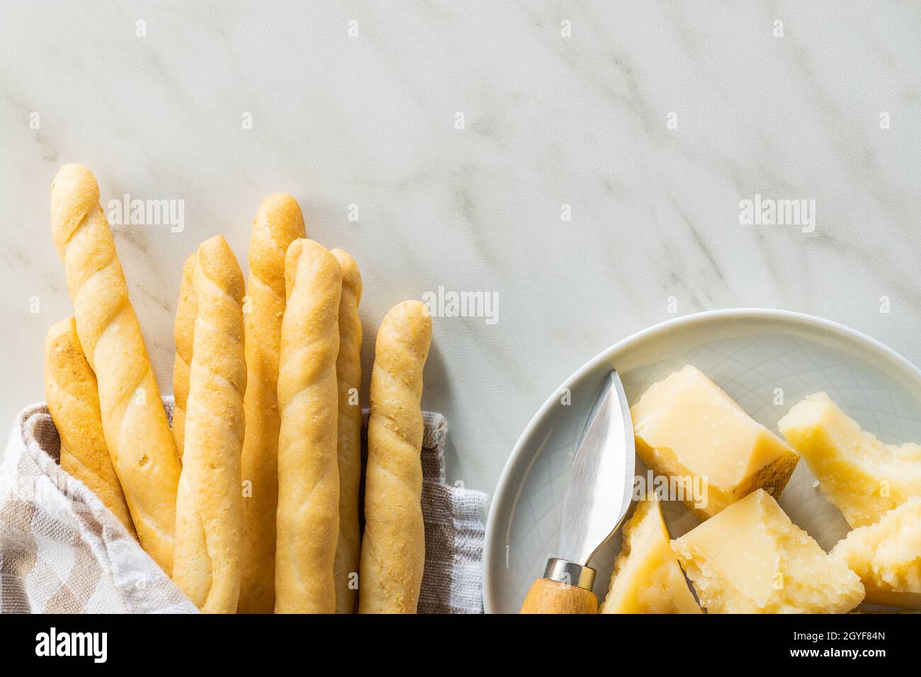 Grissini sticks and parmesan cheese. Traditional italian food on white ...