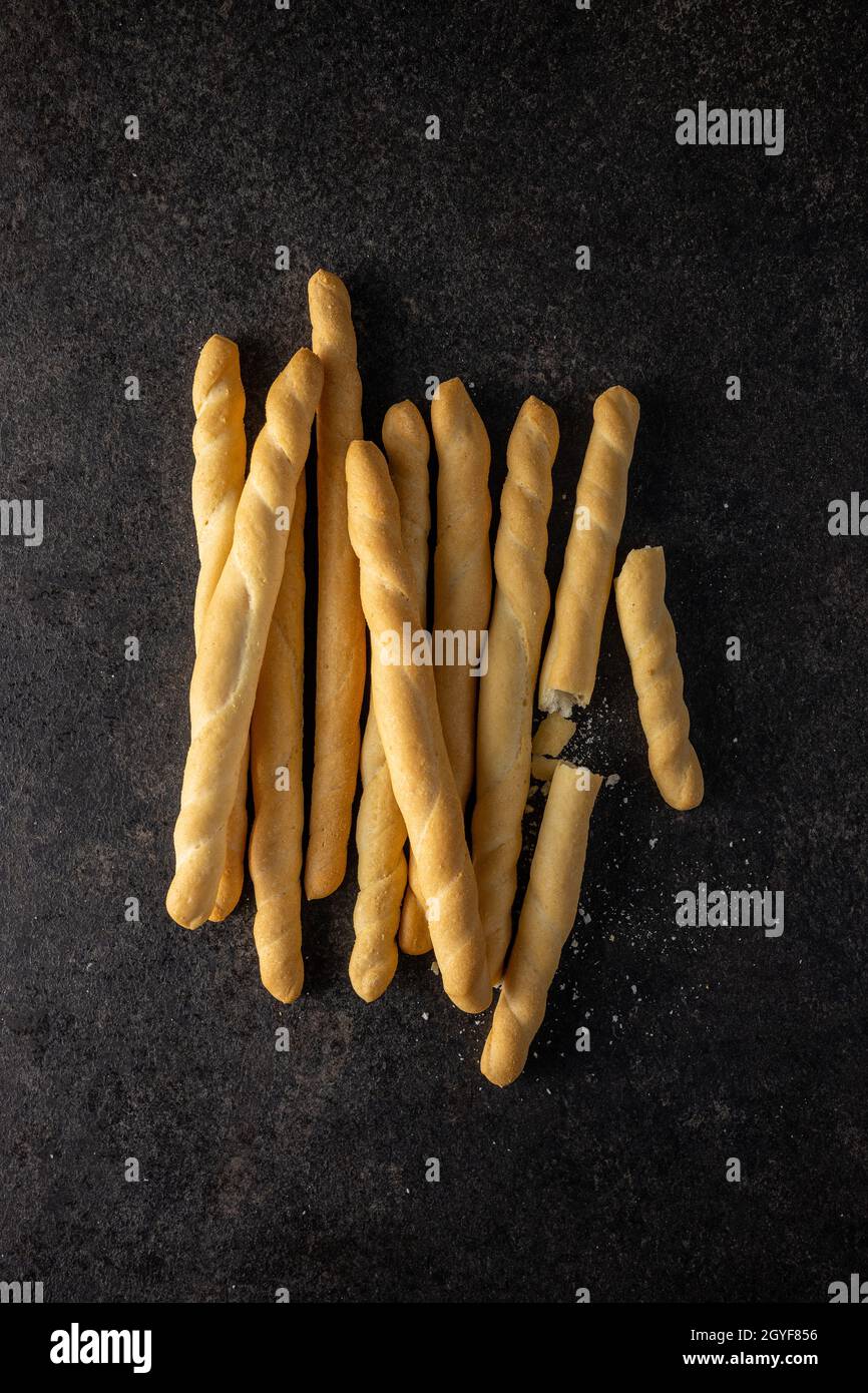 Grissini sticks. Traditional italian bread sticks on black table. Top ...