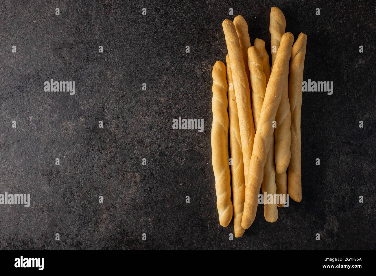 Grissini sticks. Traditional italian bread sticks on black table. Top ...
